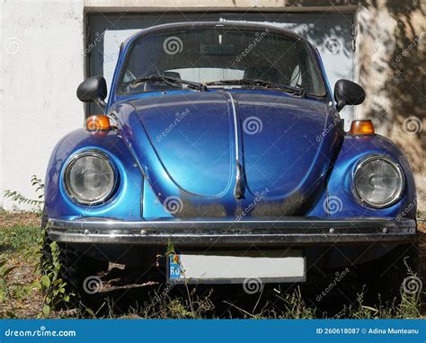 Old Blue Car Abandoned In Front Of Garage Door In Bucharest Stock Image