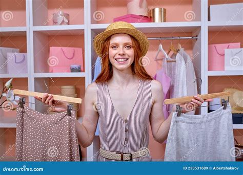 Home Closet Excited Young Redhead Woman Choosing Fashion Clothing