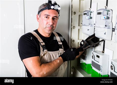 Electrician Testing Fuse Box Or Switch Box With Flashlight On Head Close Up Stock Photo Alamy