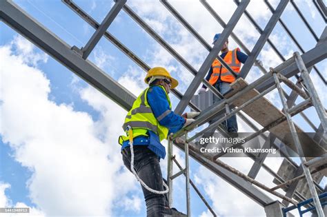 Construction Worker Work At Height And Installing New Roof At