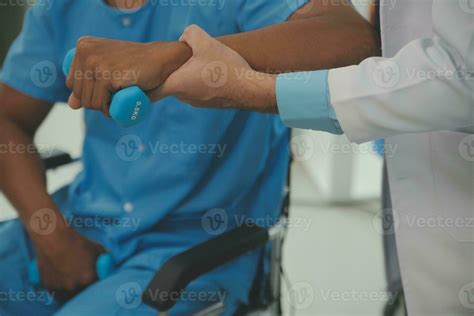 Physiotherapist Man Giving Exercise With Dumbbell Treatment About Arm