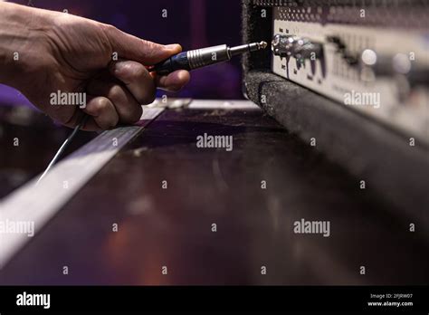 Jack Audio Connector Being Plugged Into A Socket On An Audio Device For