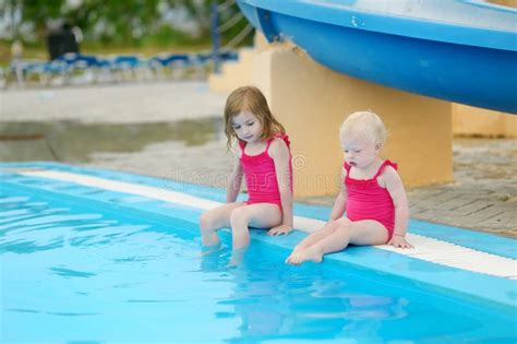 Two Sisters Sitting By A Swimming Pool Stock Image Image Of Caucasian