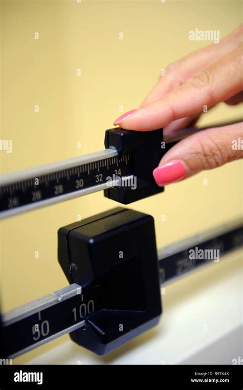 White Woman Uses Balance Scale To Measure Weight Stock Photo Alamy