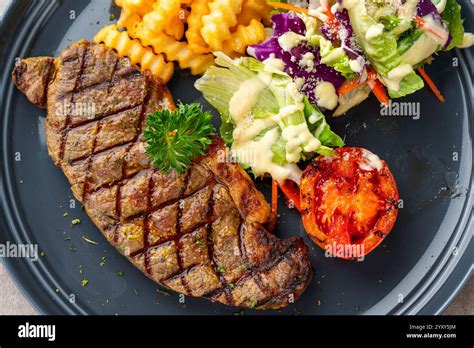 Grilled Sirloin Beef Steak With French Fries And Salads Stock Photo Alamy