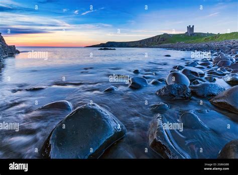 Dunstanburgh Castle At Sunrise From Embleton Bay On The Northumberland