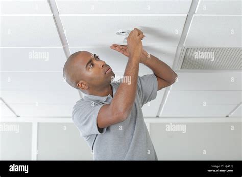 Man Fixing Ceiling Light Stock Photo Alamy