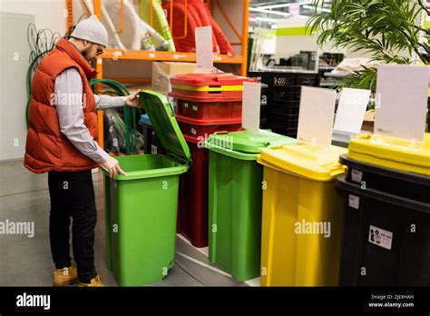 A Man Chooses A Bin For Sorting Garbage And Household Waste Stock Photo Alamy