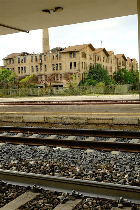 Assisi Train Station With Tracks And An Elderly Person In The