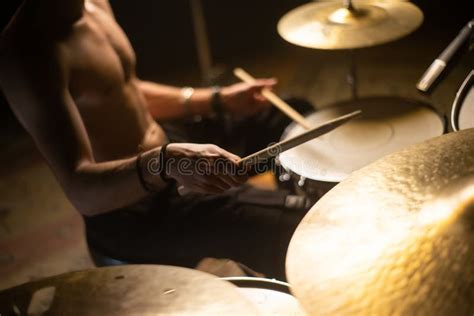 Close Up Of Man Holding Drumstick And Playing Drums And Cymbals Stock