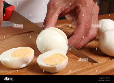 Slicing Hard Boiled Eggs In Half Stock Photo Alamy