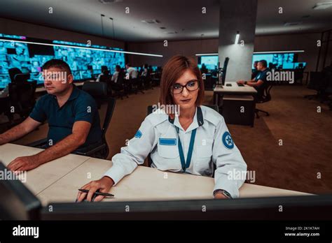 Female Security Operator Working In A Data System Control Room Offices Technical Operator
