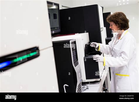 Automated Dna Sequencing A Technician Sets Up A Continuous Flow Cell Containing Samples For
