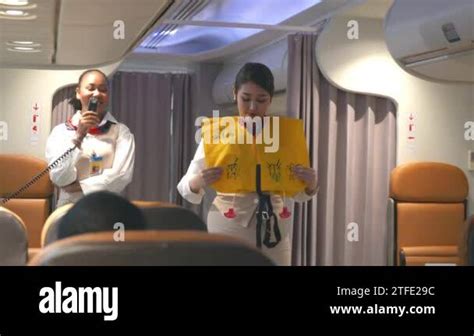 Asian Stewardess Safety Explaining Passengers Prior To Flight Take Off