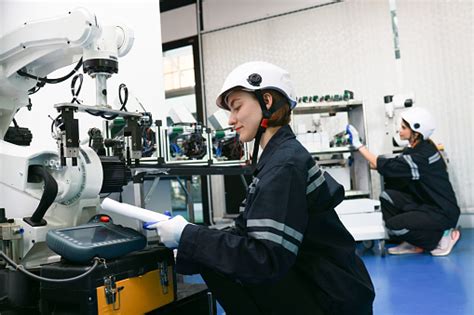 two female caucasian mechatronics engineers working to check and