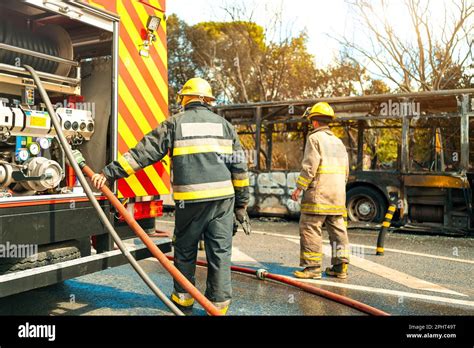 Rescue Team Of Firefighters Arrive On The Car Crash Fired Passenger Bus