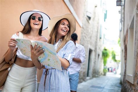 Smiling Gorup Of Friends With Map Tourism Travel Leisure Holidays
