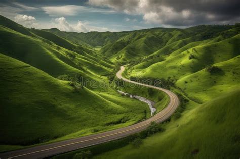 Scenic Highway With Rolling Green Hills And A Winding Stream Stock