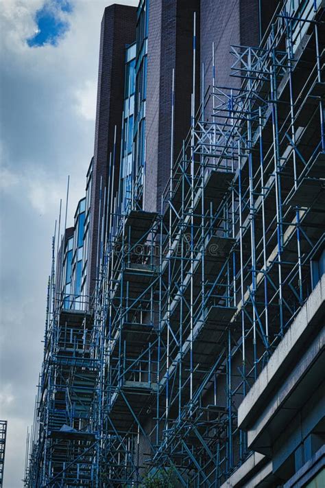 Urban Construction Site With Intricate Scaffolding Against A Modern