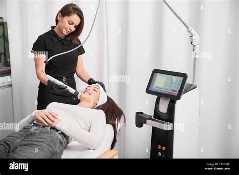 Doctor Cosmetologist Using Radiofrequency Microneedling Device While