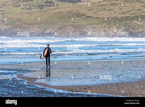 Polzeath Surfing A Surfer Walking Out Of The Sea On Polzeath Beach On