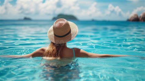 A Picturesque Scene Of A Young Woman Lounging In A Pool Stock