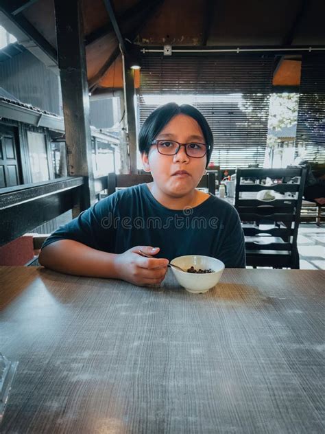 Young Girl Is Having Breakfast At The Tropical Island Resort Stock