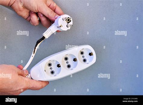 Burnt Power Cable With Tee Socket After Overloading With Electrical Appliances Stock Photo Alamy