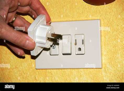 110v Power Socket With A Caucasian Hand Inserting An Adapter Stock Photo Alamy