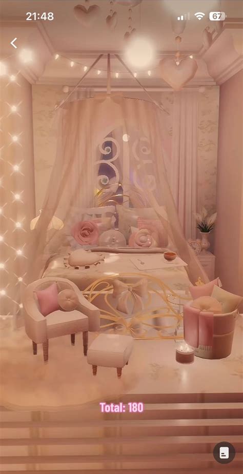 A Bedroom Decorated In Pink And White With Lots Of Lights On The