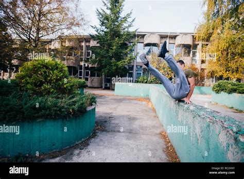 Athletic Parkour Guy Doing Backflip And Tricks While Jumping Off And