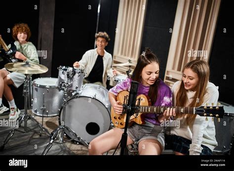 Focus On Cute Teenage Girls Playing Guitar And Singing With Their