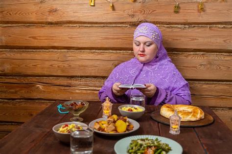 Muslim Woman In Purple Hijab Reads Dua At Festive Table Eid Al Fitr Stock Image Image Of