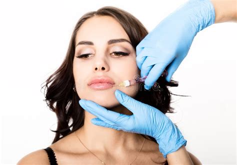 Young Woman Gets Beauty Injection In Eye And Lips Area From Beautician
