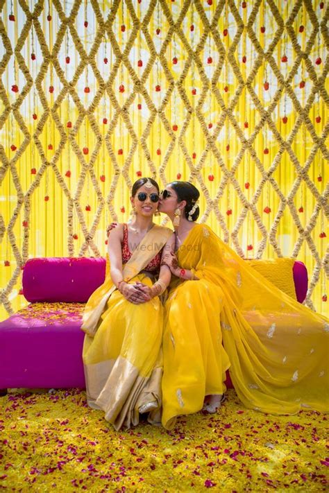Photo Of Two Sisters Pose Together On The Haldi Ceremony Haldi
