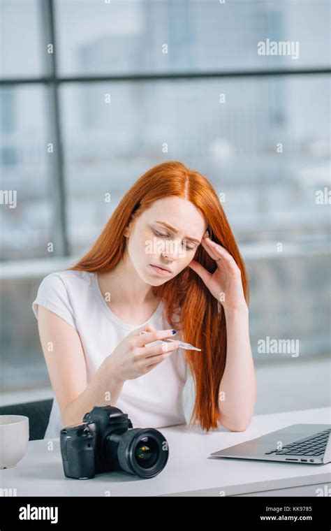 Girl With Thermometer Sitting On Laptop And Looking At Network What To Do Stock Photo Alamy