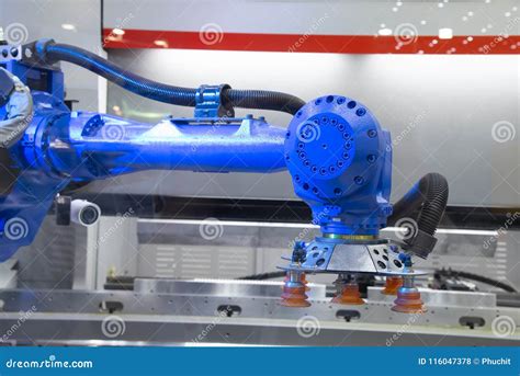 The Robotic Arm Handing The Raw Material For CNC Lathe Machine Stock Photography