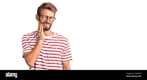 Handsome Blond Man With Beard Wearing Casual Clothes And Glasses
