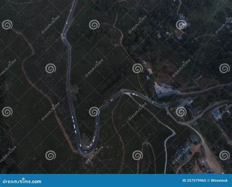 Aerial View Of A Curvy Road Passing Through Green Tea Plantations In