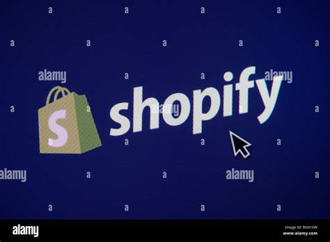The Logo Of Shopify Is Seen On A Computer Screen Along With A Mouse