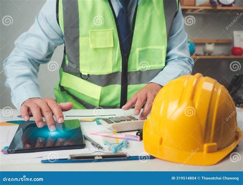 Architect Or Engineer Using Tablet To Work On Table Cost Calculation