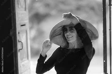Playful Mature Woman Wear A Hat Glasses Dark Dress And Dancing Shoes
