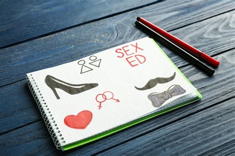 Premium Photo Notepad With Words Sex Ed And Drawings On Wooden Table