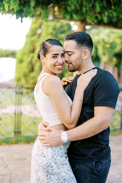 Premium Photo Turkish Guy Hugs Smiling Girl Waist Touching Her Cheek