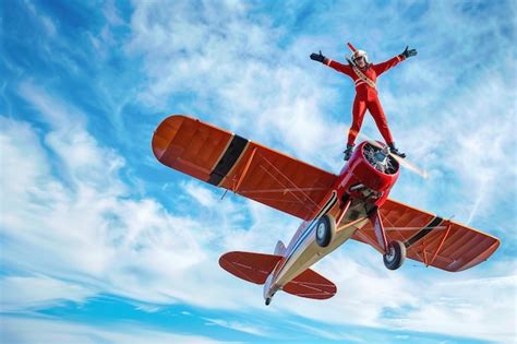 Premium Photo A Person In A Red Suit Is Standing On A Plane With The