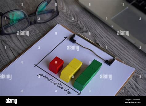 Upward Graph With Text Productivity On Table With Glasses And Laptop Business Concept Stock