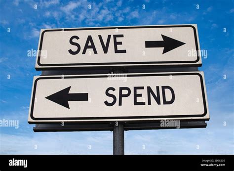 Save Vs Spend White Two Street Signs With Arrow On Metal Pole With