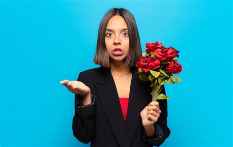 Premium Photo Young Pretty Woman Holding A Bouquet Of Roses