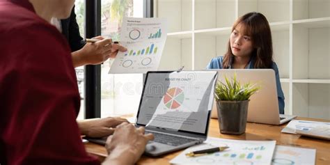 Business Team Analysis Financial Data And Discuss Strategy In Modern