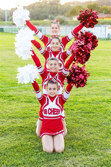 Group Of Cheerleaders In The Field Cheer Photography Cheer Poses Cheer Picture Poses